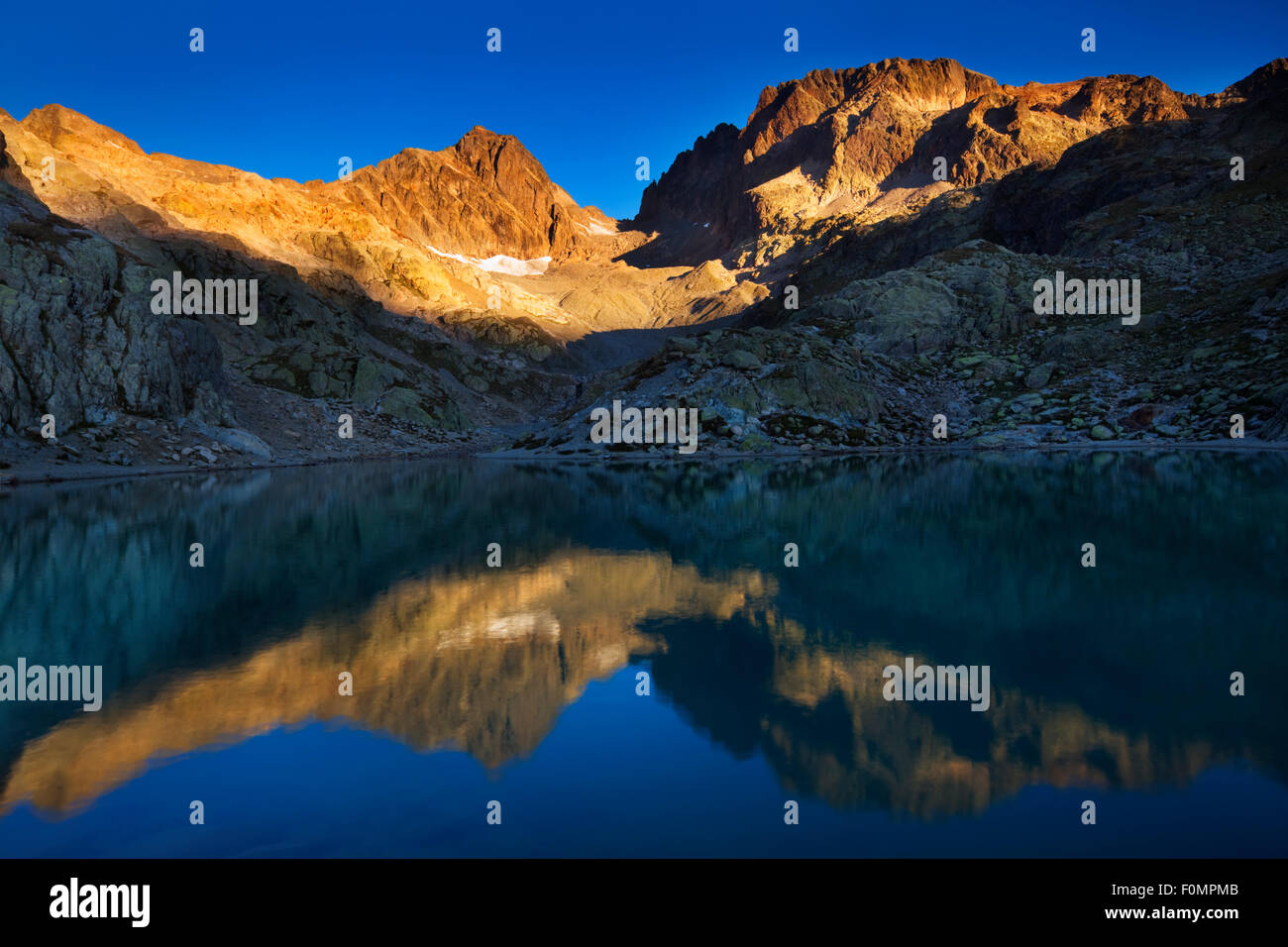 Aiguilles Rouges mountains reflected in Lac Blanc at sunrise, Haute ...