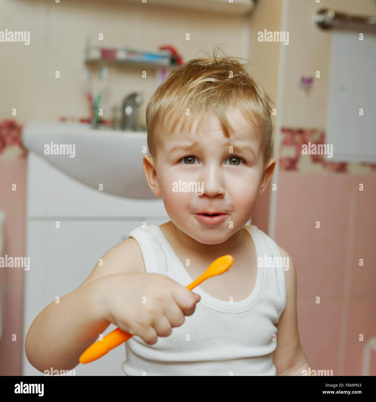 little boy learns to brush teeth Stock Photo - Alamy