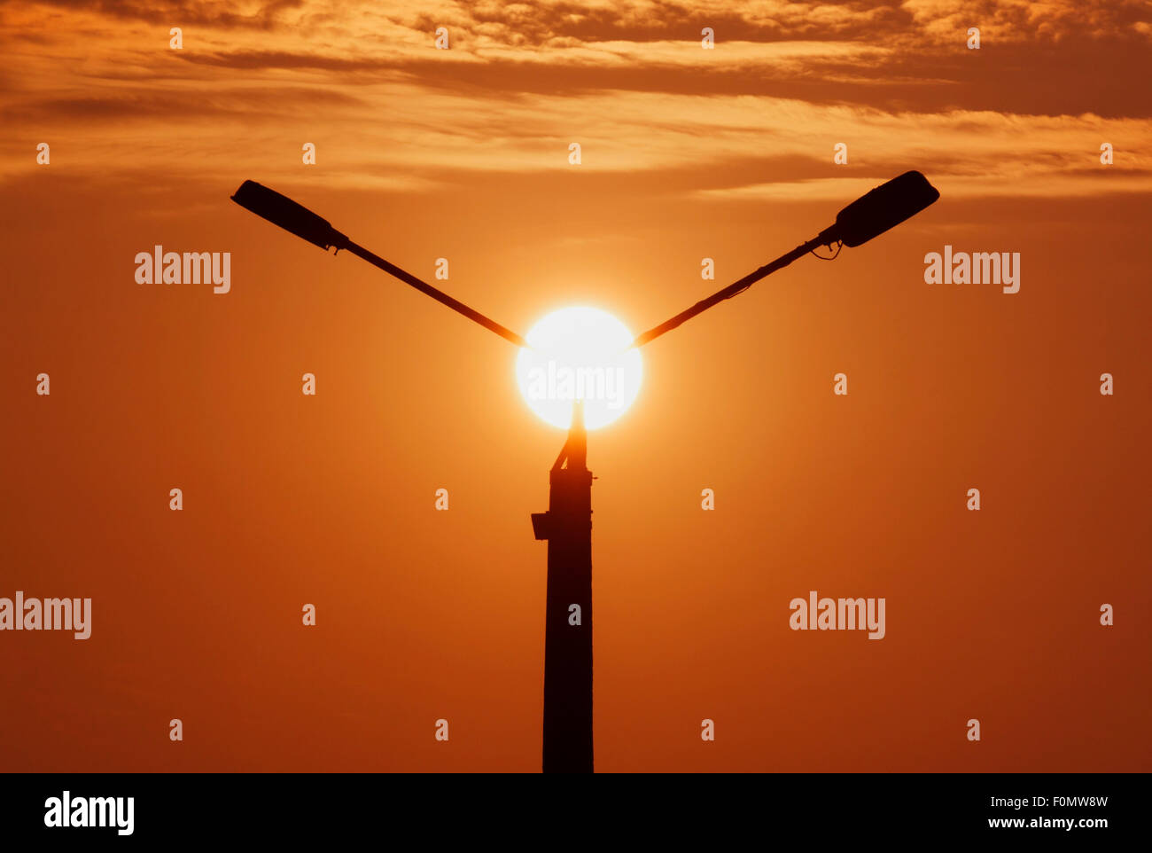 rising sun behind street lantern Stock Photo - Alamy