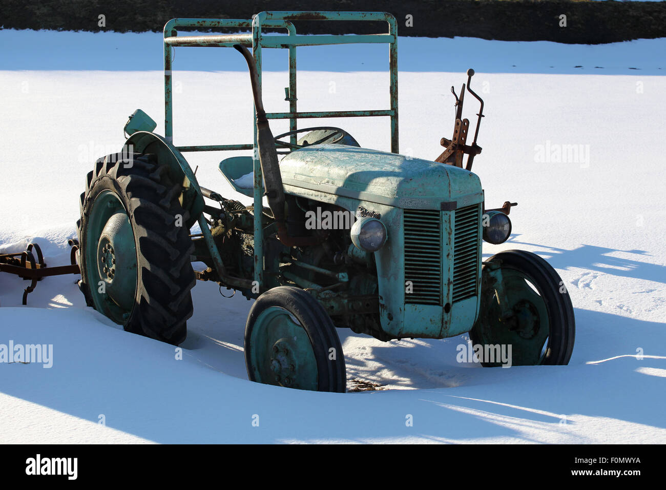 Old tractor in the snow hi-res stock photography and images - Alamy