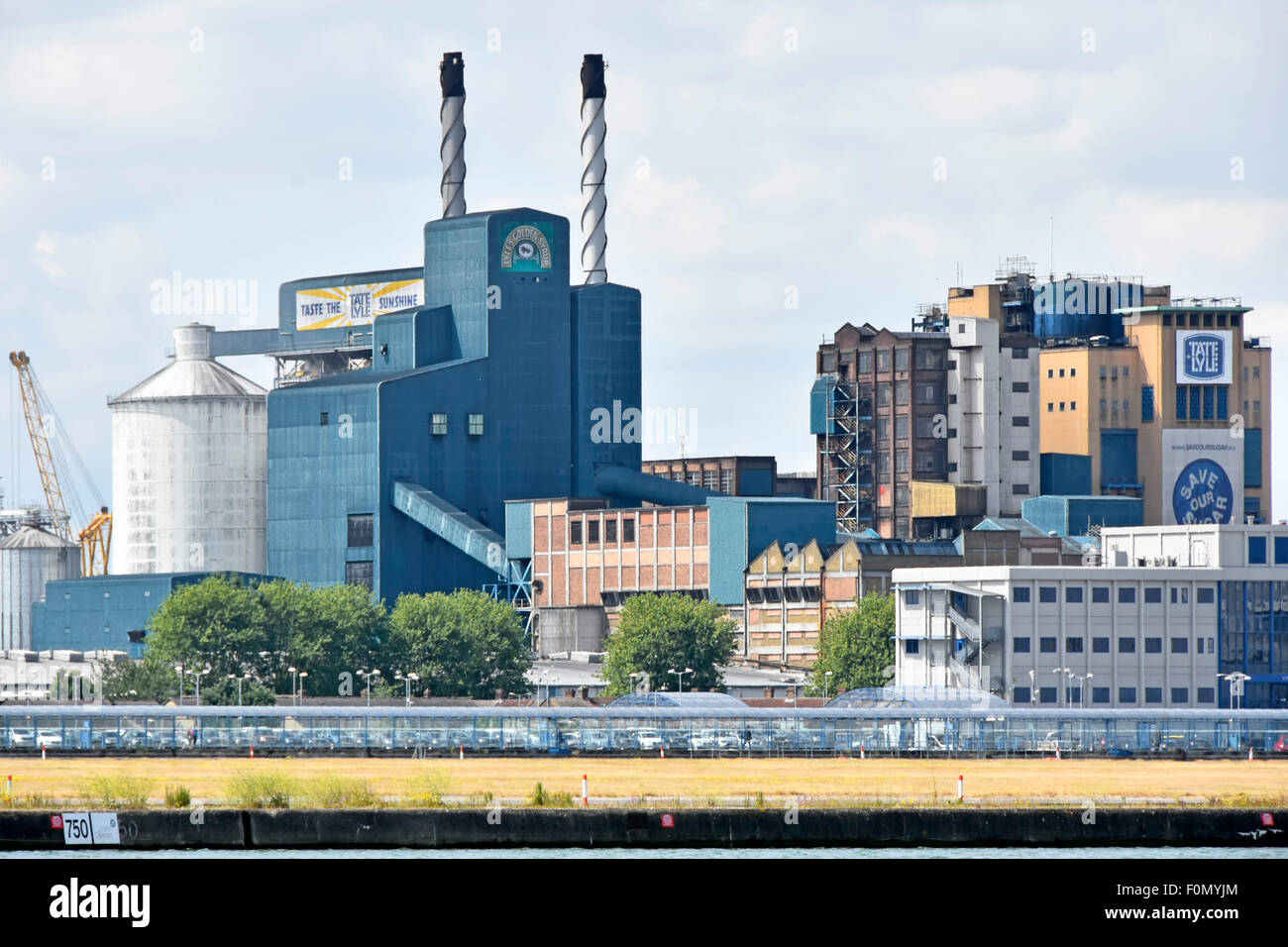 Tate and Lyle sugar refinery factory buildings seen beyond London City ...