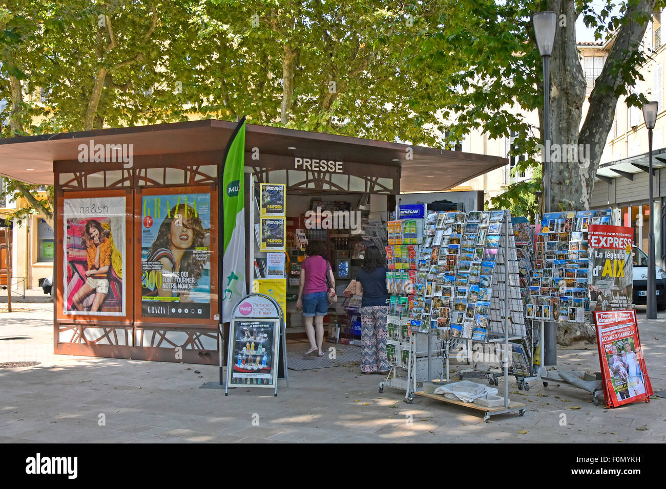 Customer at modern French Presse newspaper kiosk pavement postcard ...
