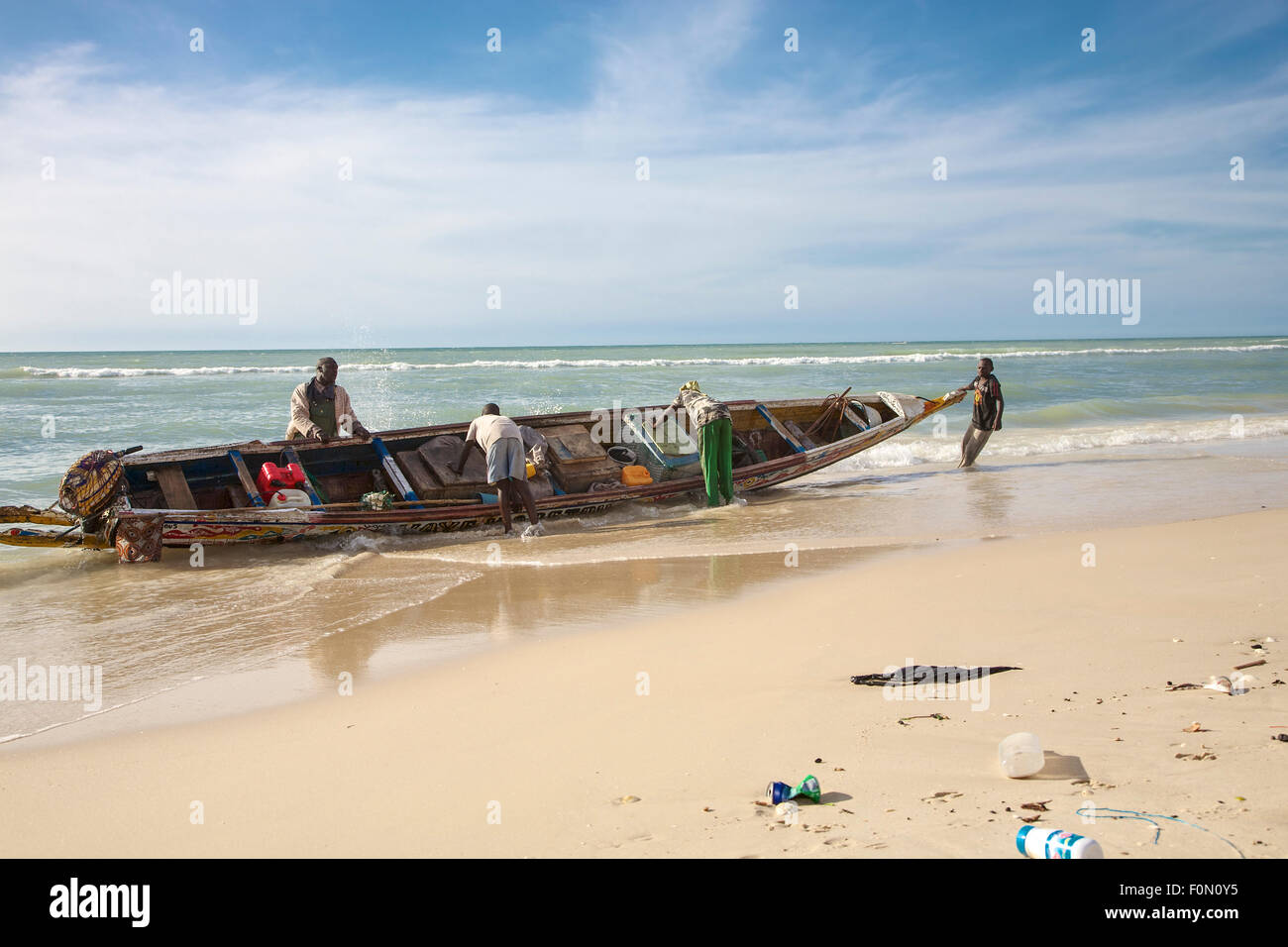 Unidentified Fisher men pulling back the ship on the beach of Saint ...