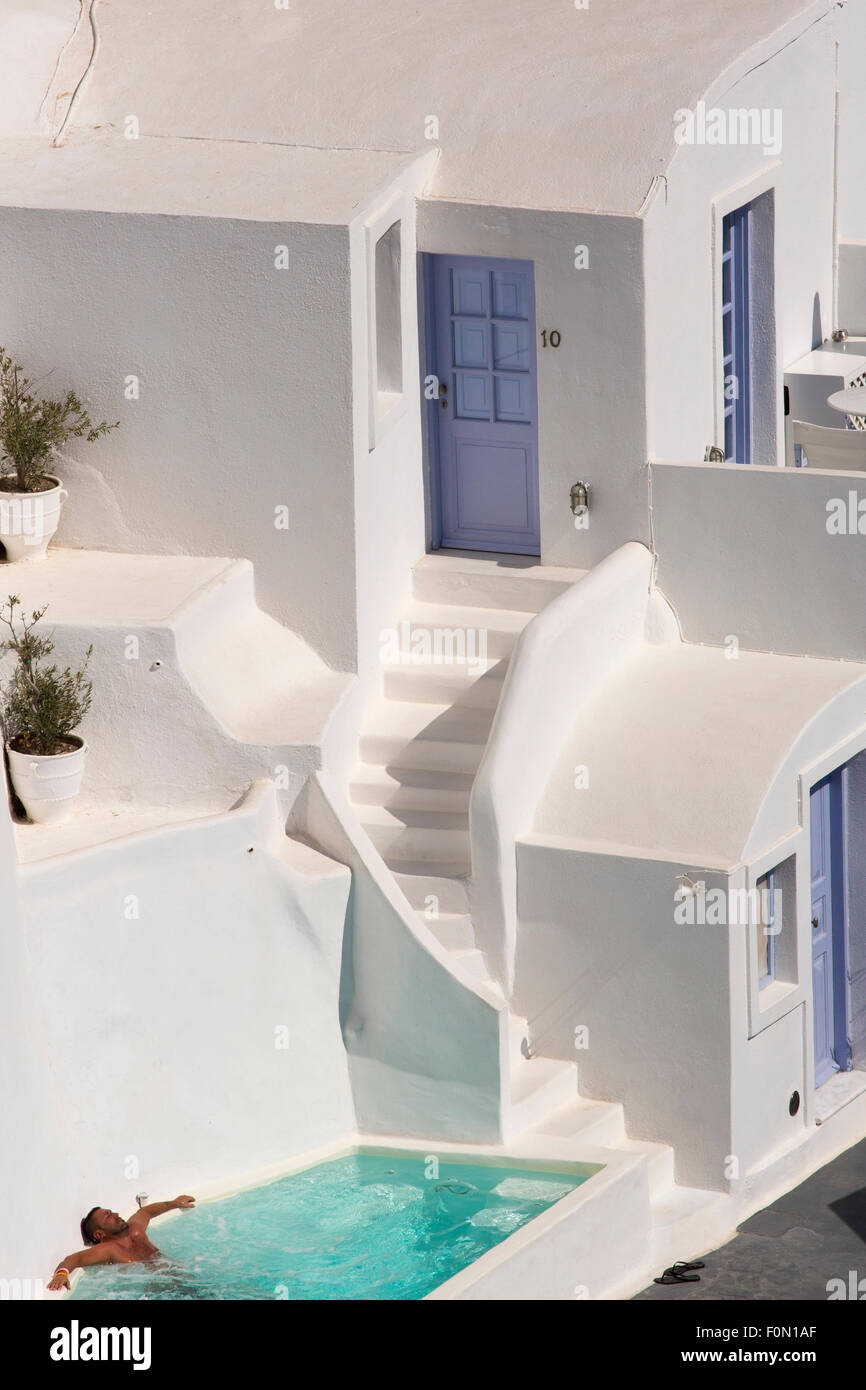 Unidentified man in a swimming pool outside a the traditional white ...