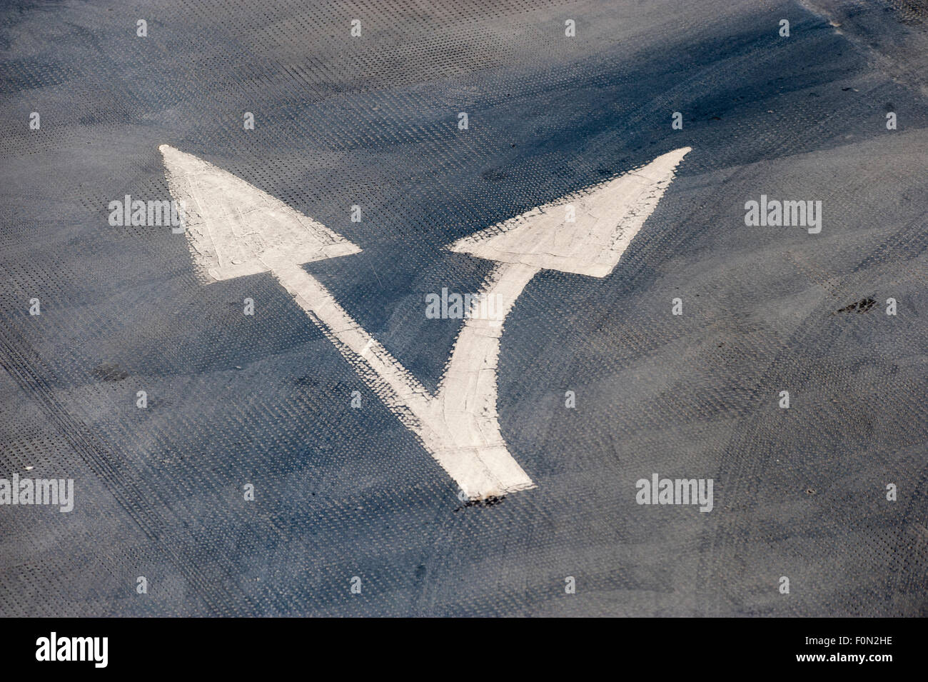 Direction arrows in a multi storey car park advise drivers of their directional options Stock ...