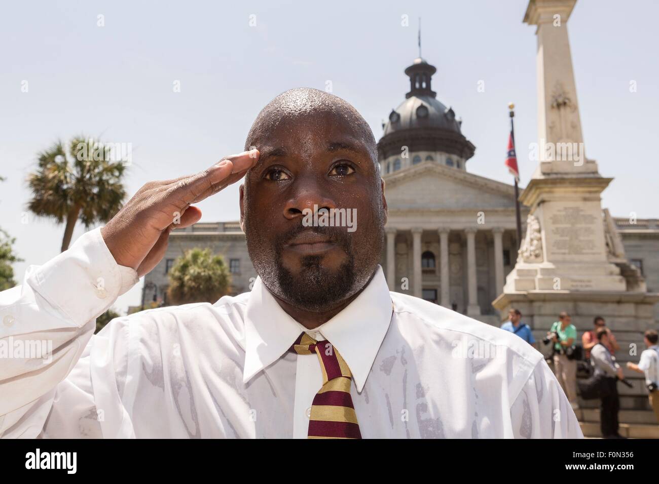 A mourner salutes as the horse-drawn caisson carrying the casket of ...