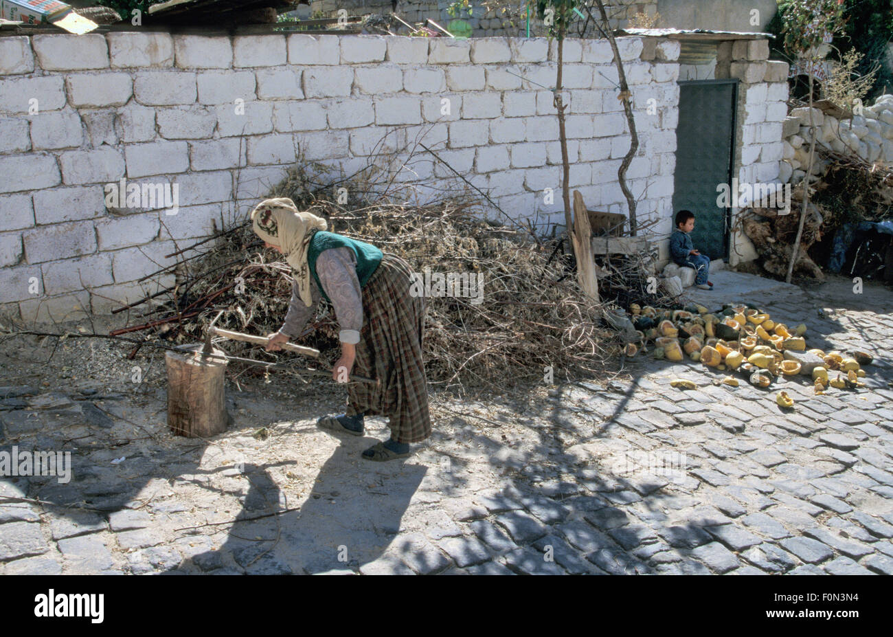 Woman chopping wood in a village in Turkey Stock Photo - Alamy