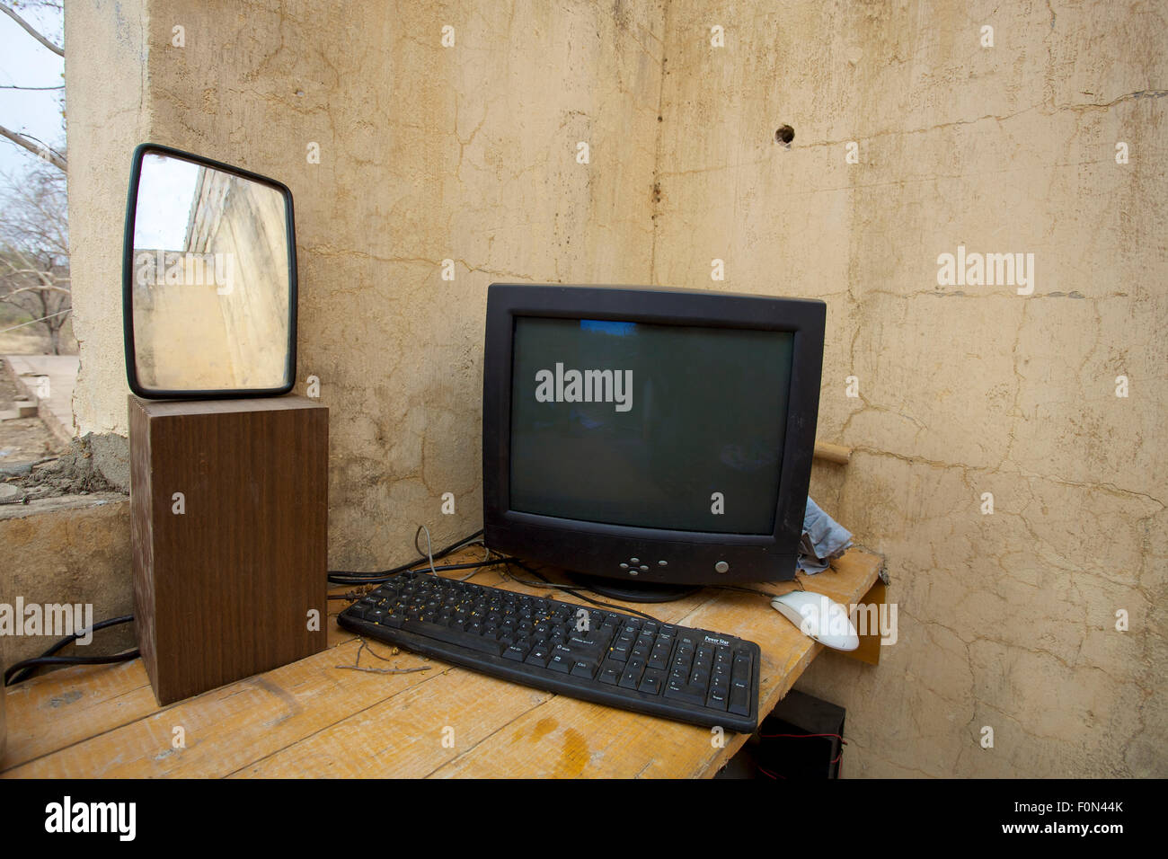 Old computer and a mirror in the office zone, every device is connected ...