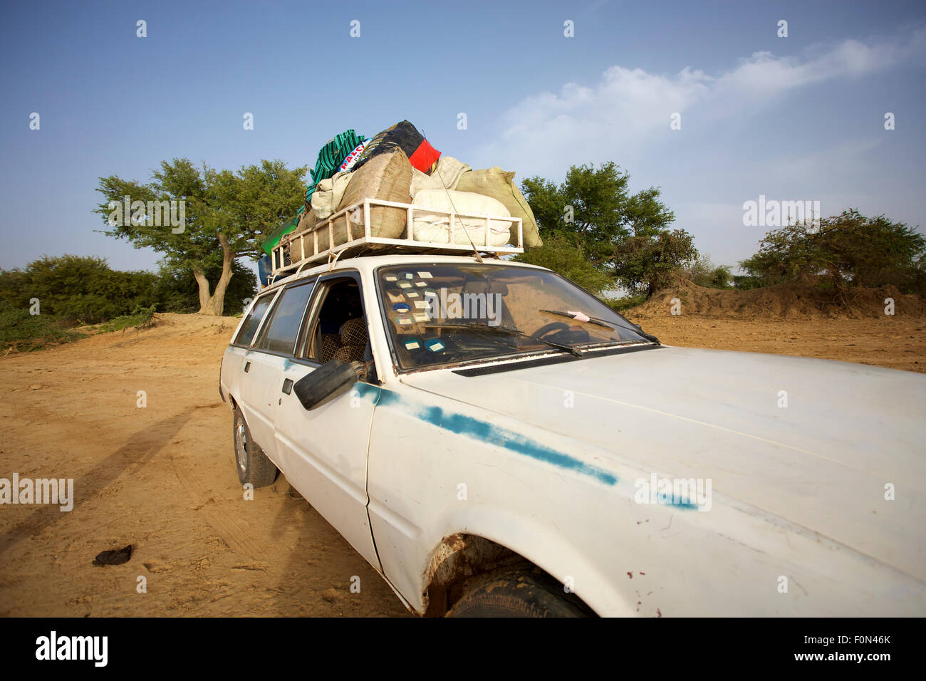 Over loaded taxi on a road of Mali Stock Photo - Alamy