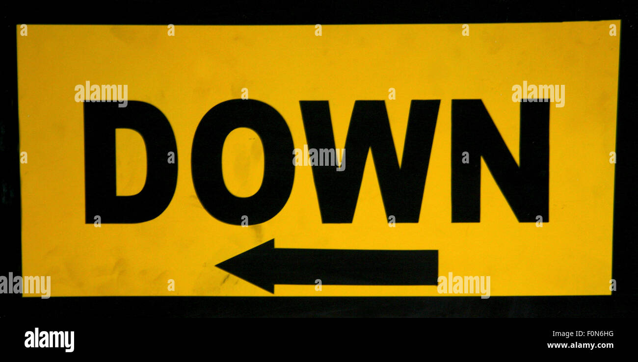 Signboard giving a direction on yellow background Stock Photo - Alamy