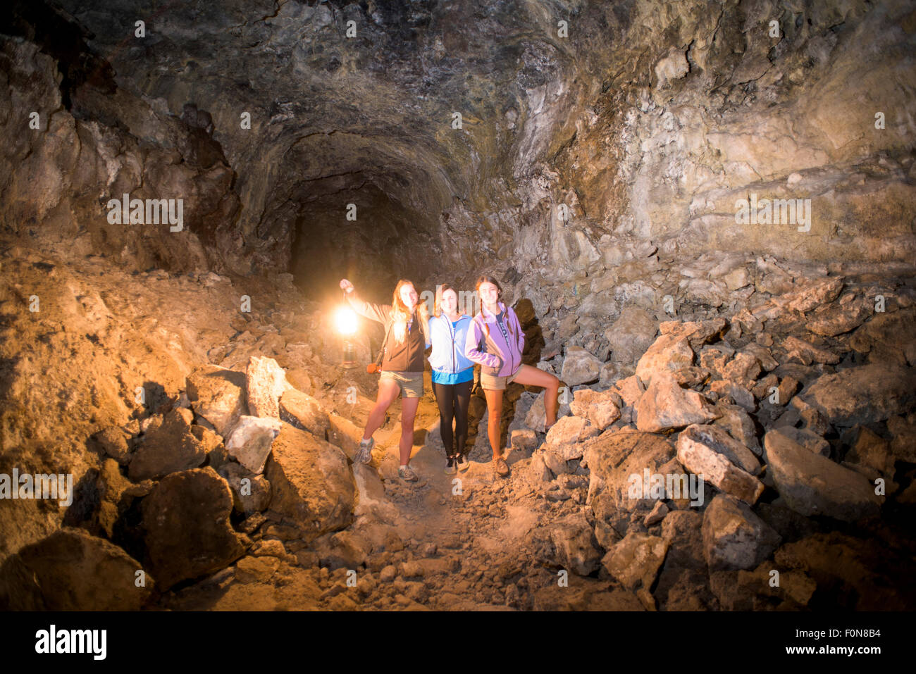 Group of girls posing in dark caves Stock Photo - Alamy