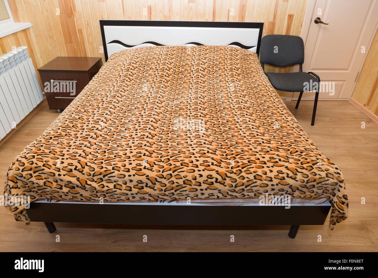 the big bed is made by a cover costs in the room Stock Photo - Alamy