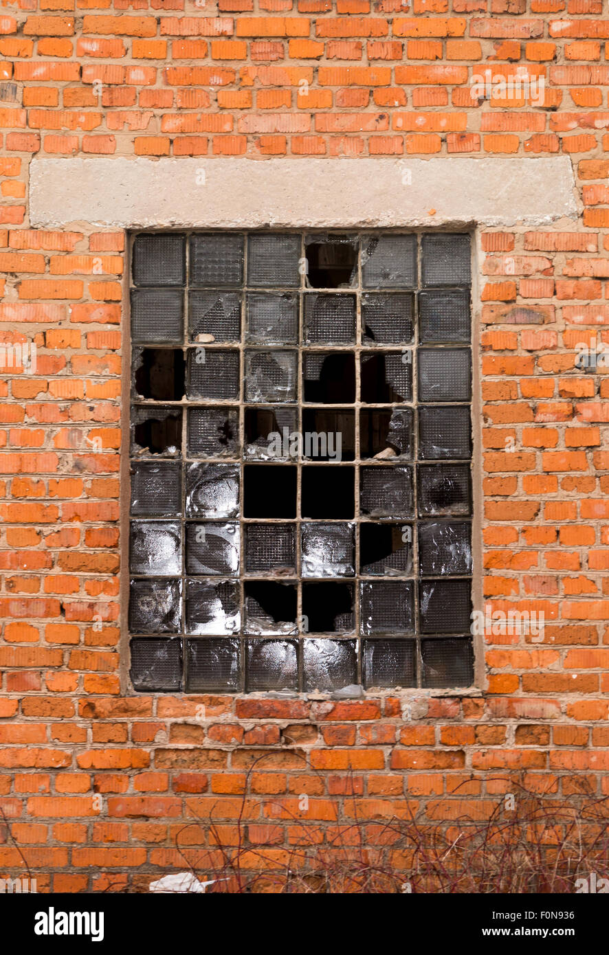 An old brick building with broken windows Stock Photo - Alamy
