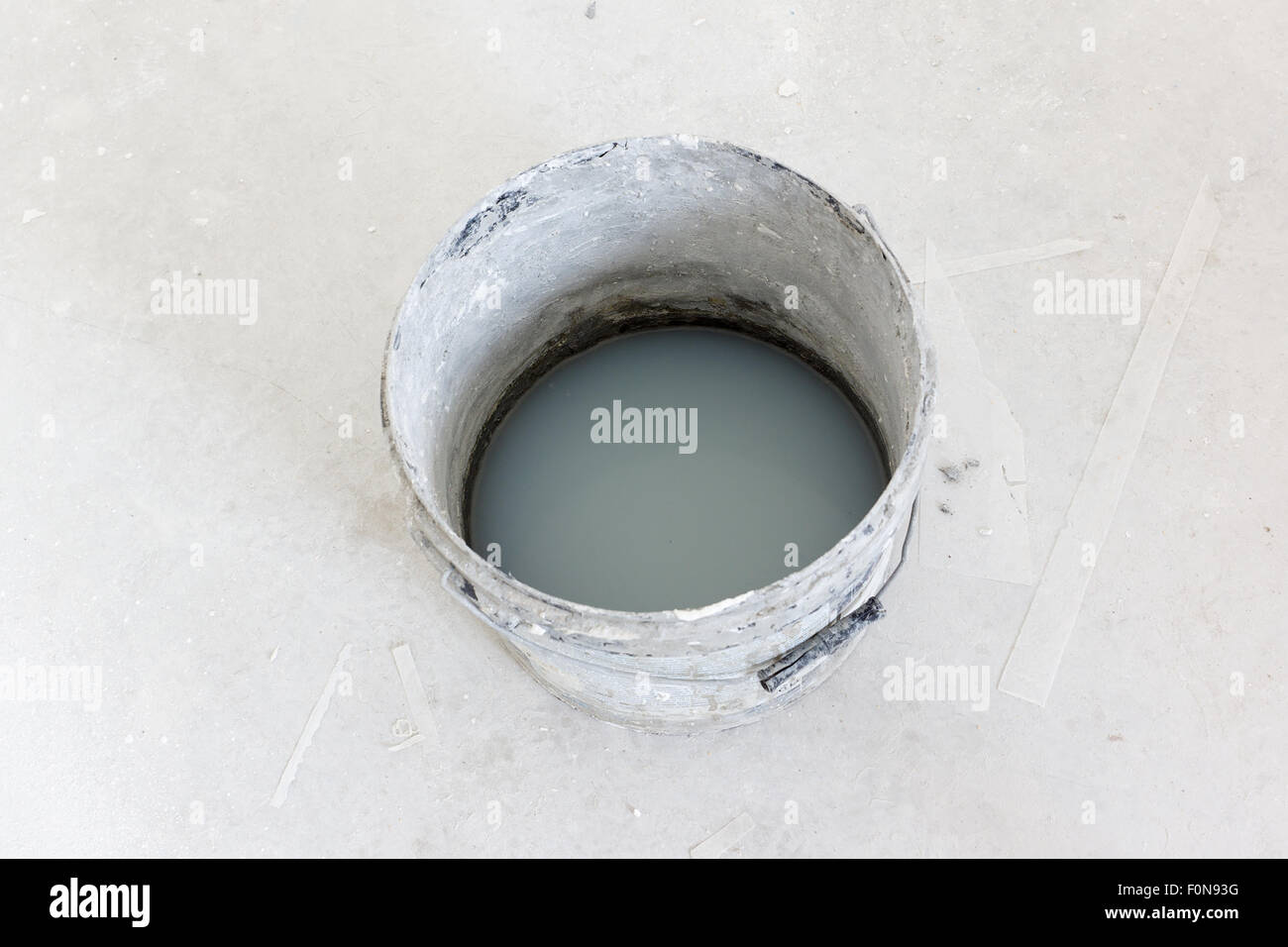 the bucket with dirty water costs indoors where repair was carried out ...