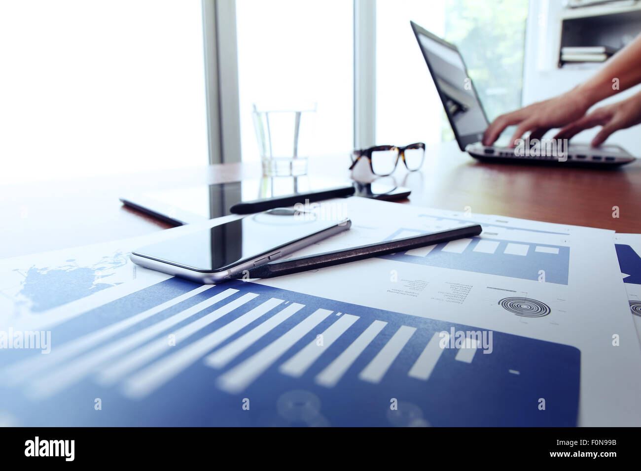 business documents on office table with smart phone and digital tablet ...