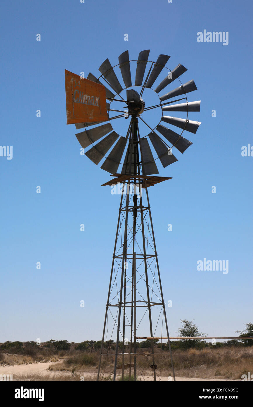 Detail of a bore water wind mill in action with a blue sky somewhere in ...