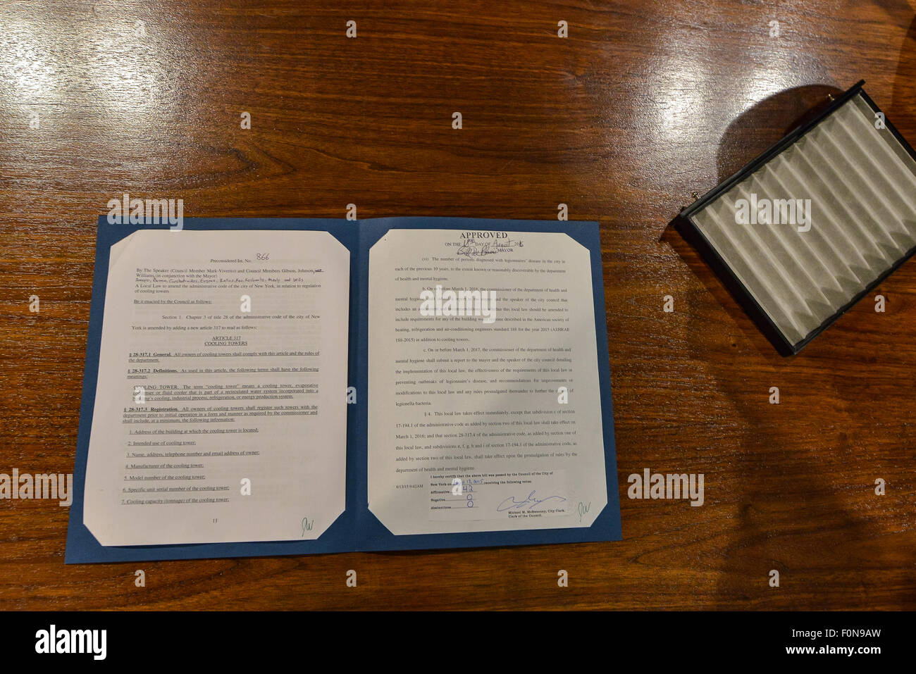 The signed document for Intro. 866 sits on the Mayor's Blue Room desk ...