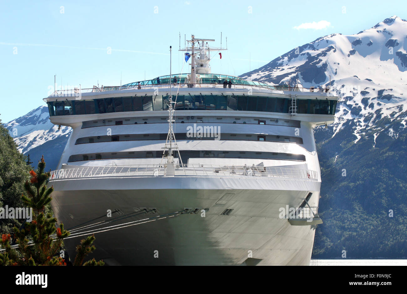 Big cruise ship docked near small port in Alaska Stock Photo - Alamy