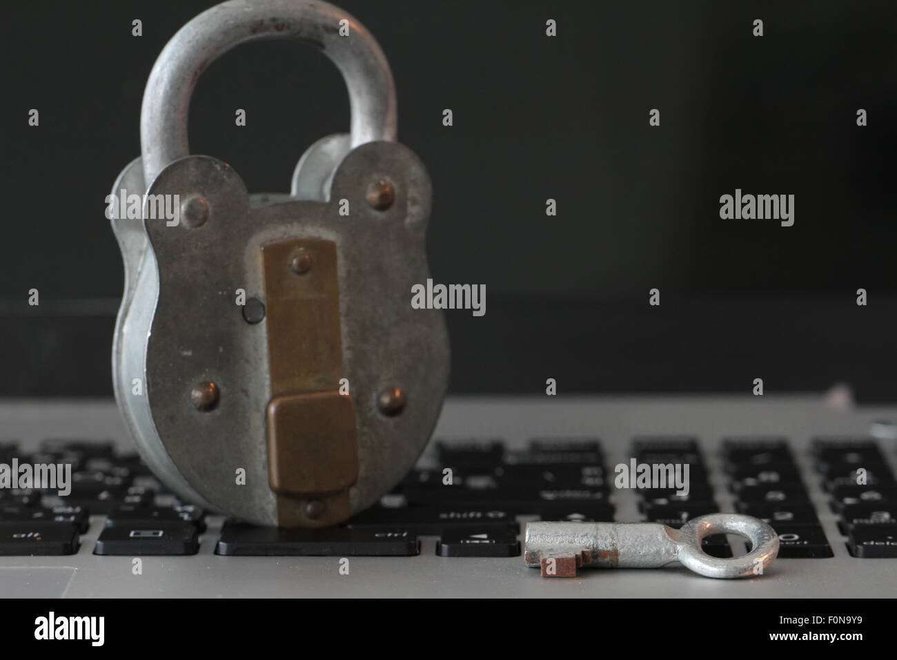 Internet security concept-old padlock and key on laptop computer ...