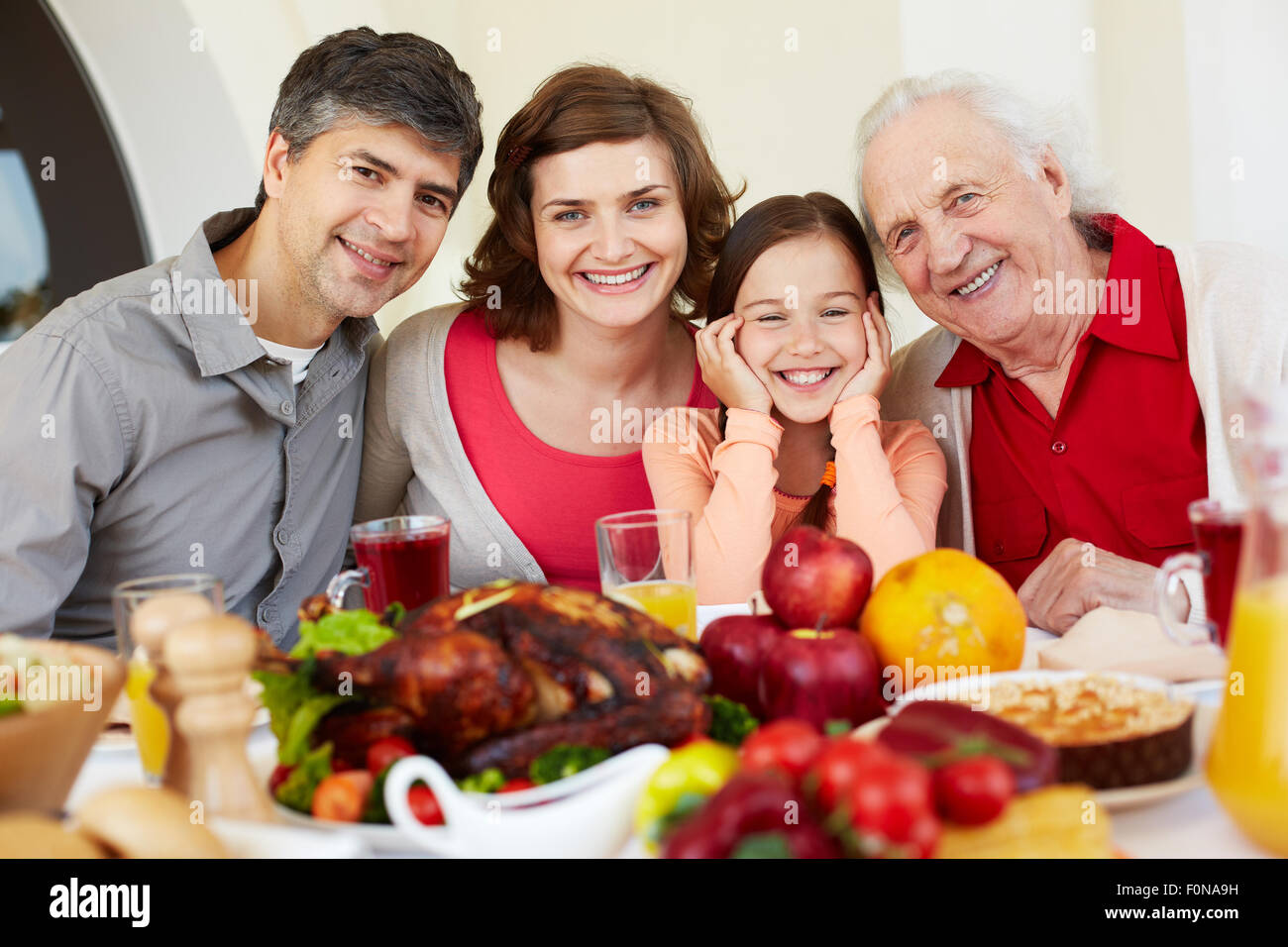 Family of four gathering for dinner Stock Photo - Alamy