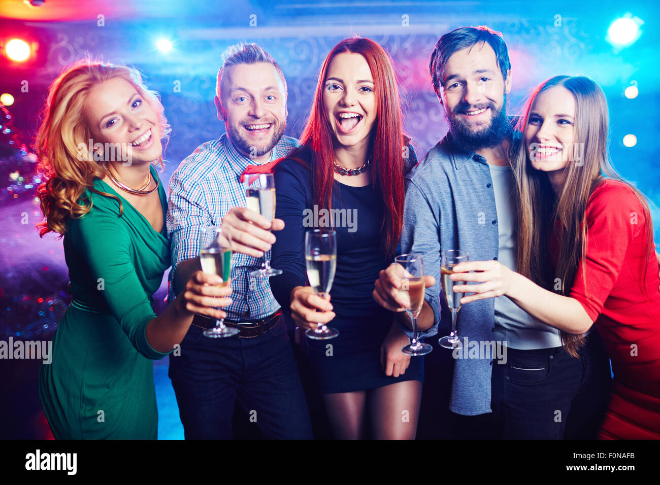 Joyful friends drinking wine at nightclub Stock Photo - Alamy