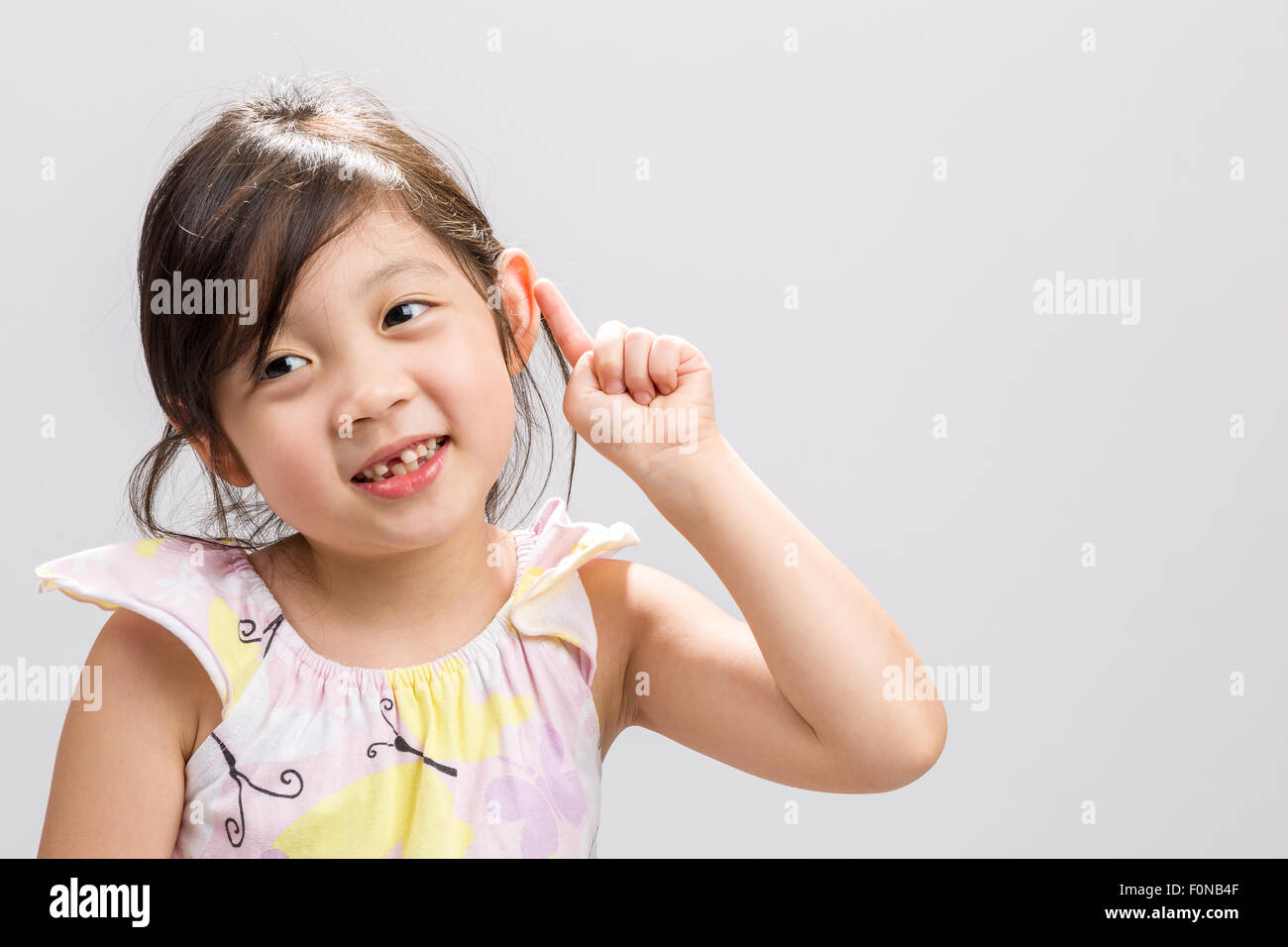 Cute Asian girl expressing smart concept, studio isolated white ...