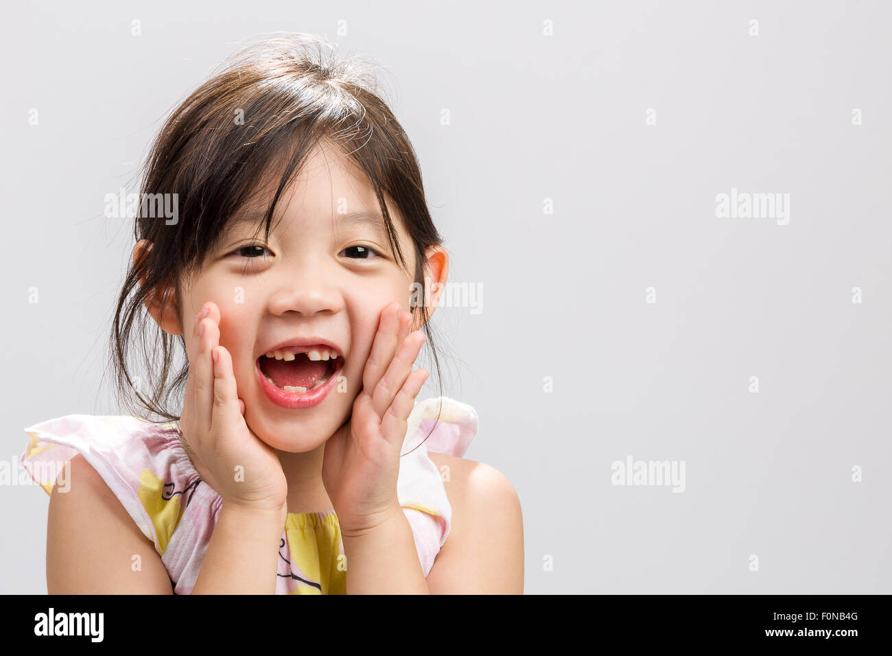 Cute Asian girl shouting out loud, studio isolated white background ...