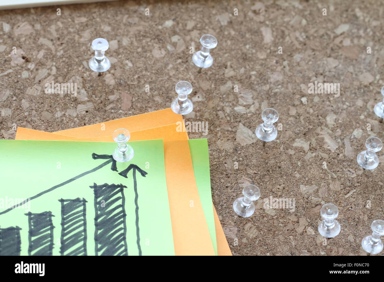 close up of pin and hand drawn business strategy graph chart on sticky ...