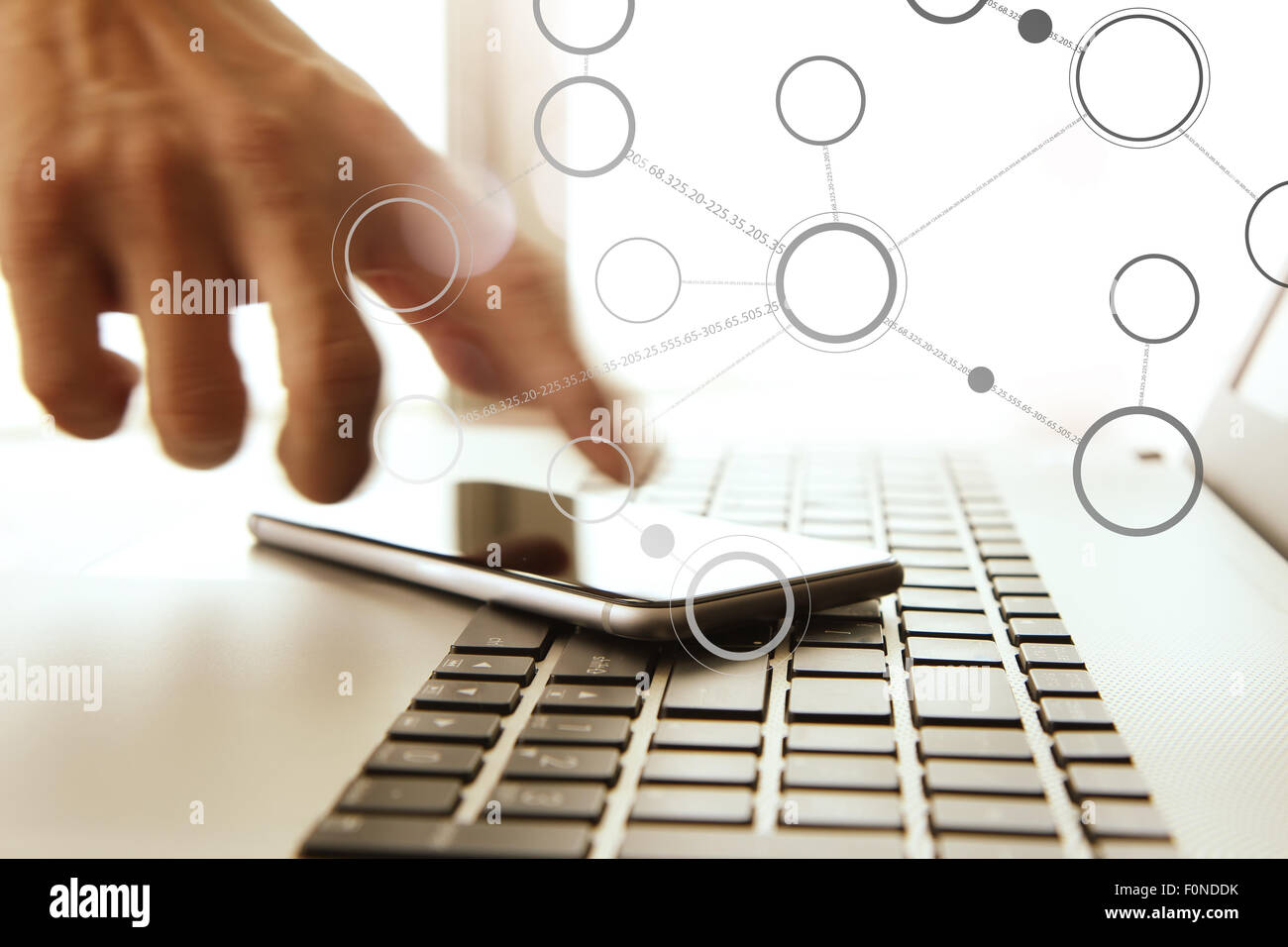 Businessman hand using laptop and mobile phone in office Stock Photo ...