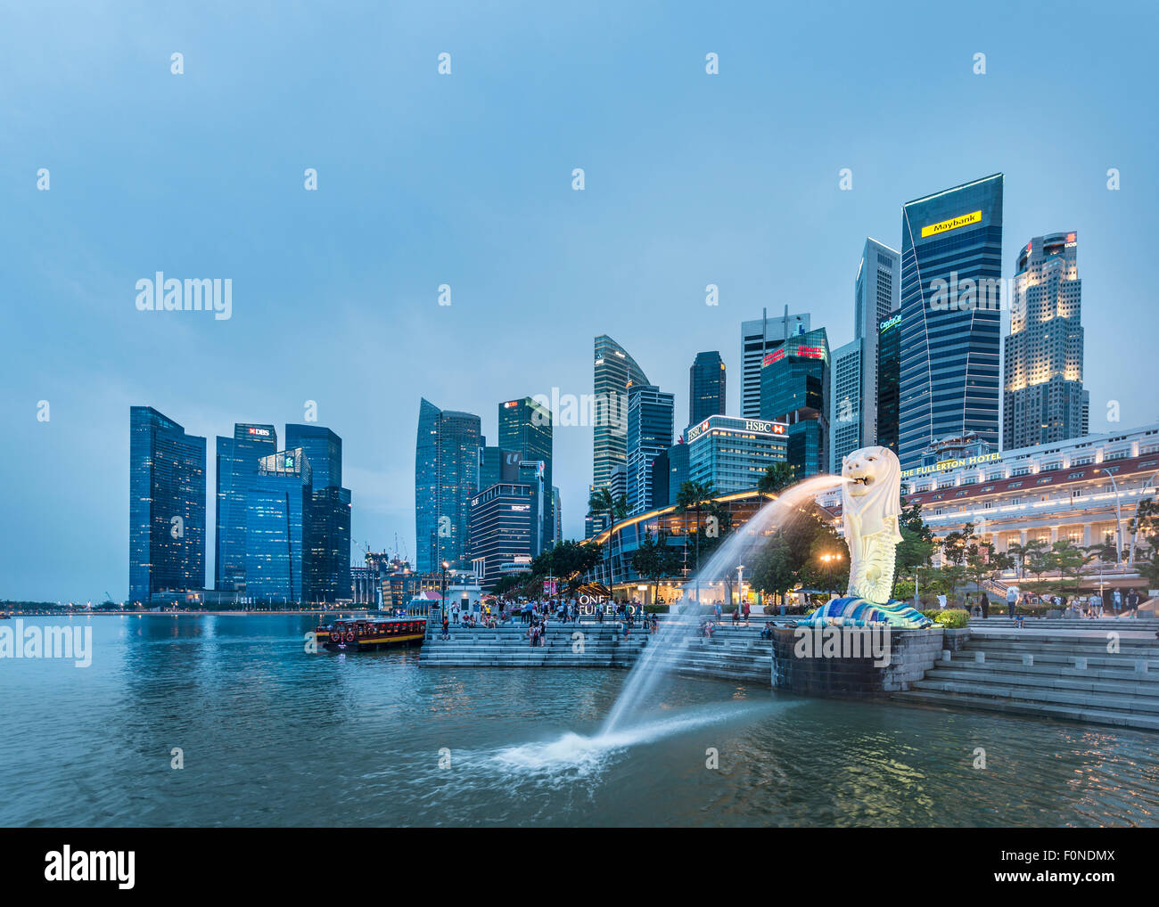The Merlion, symbol of the city of Singapore, city center skyline ...