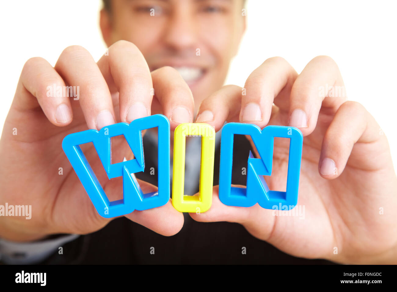 Happy businessman holding letters spelling the word "WIN Stock Photo ...