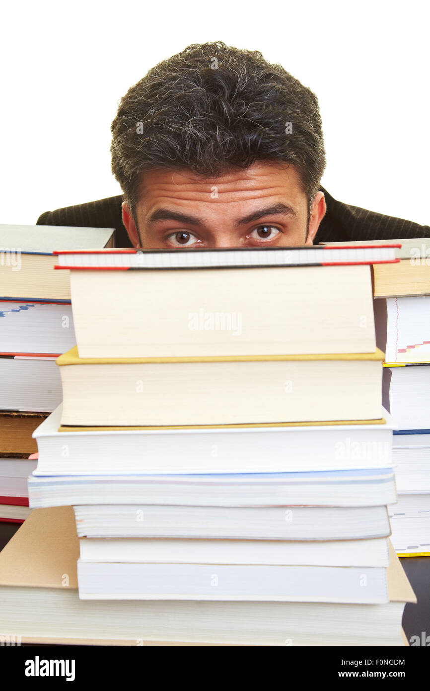 Man hiding behind a stack of books Stock Photo - Alamy