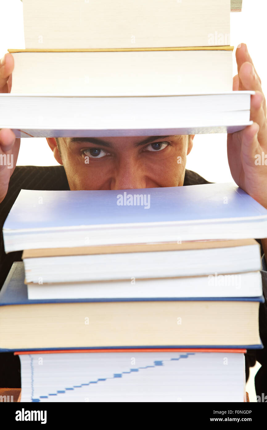 Man looking through a gap in a stack of books Stock Photo - Alamy