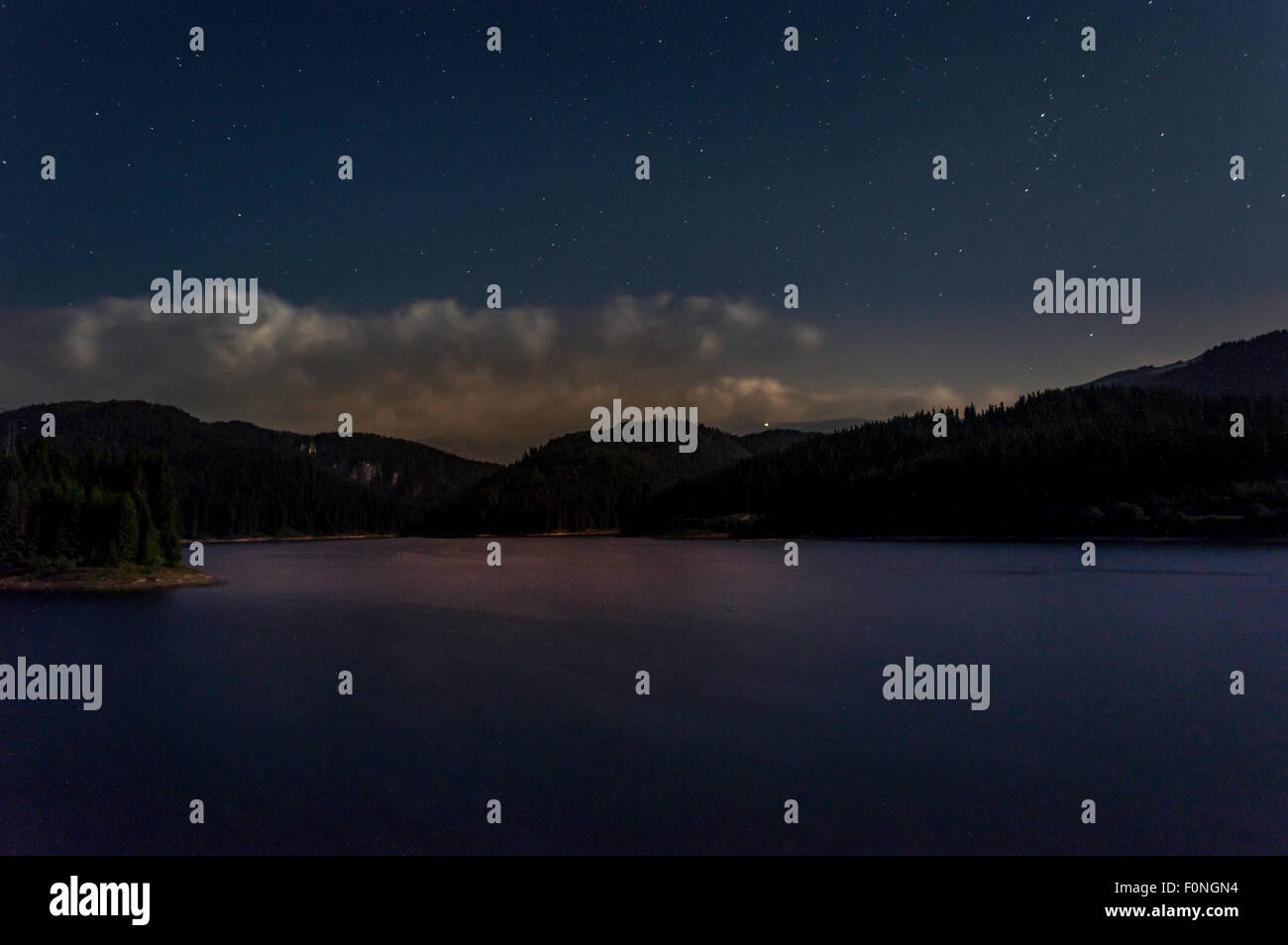 stars moving in night sky over mountain lake Stock Photo - Alamy