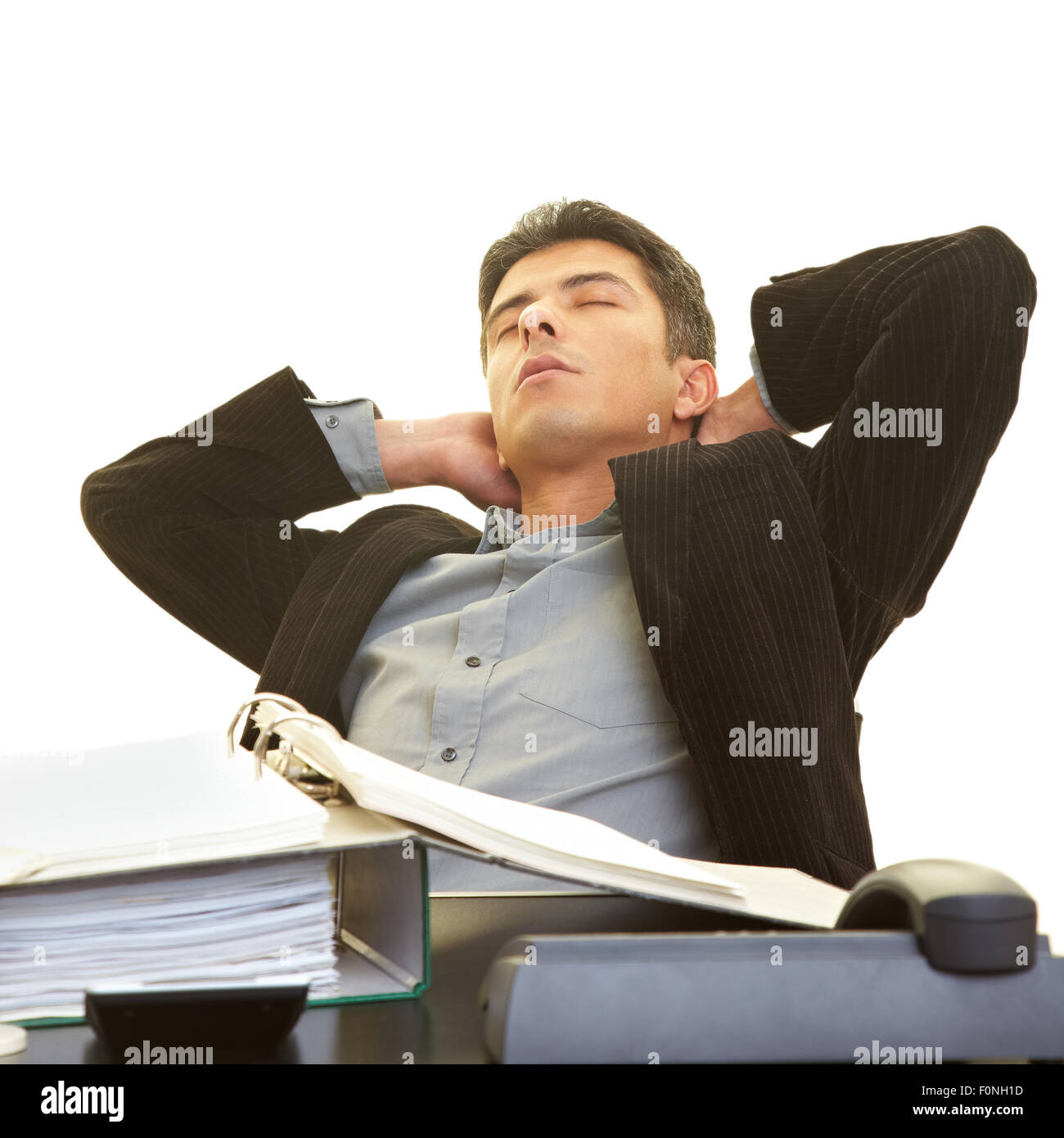 Businessman on his desk leaning back and relaxing Stock Photo - Alamy