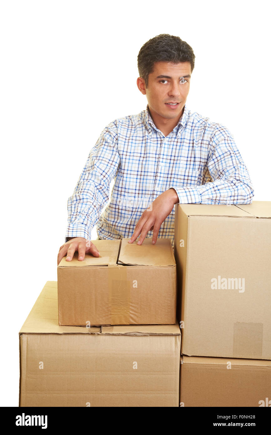 Man standing behind a stack of cardboard boxes Stock Photo - Alamy
