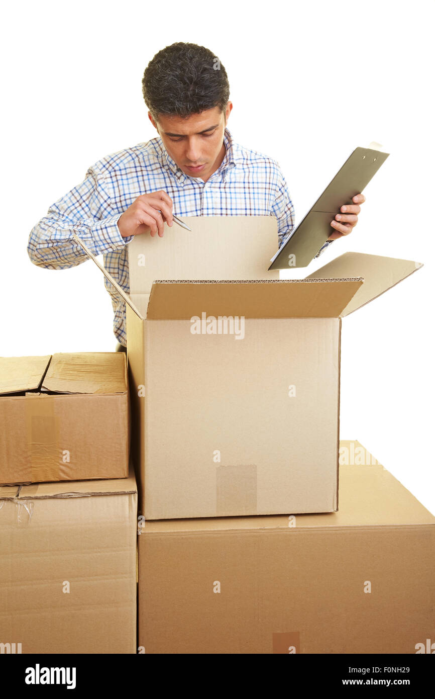 Man with clipboard counting the content of cardboard boxes Stock Photo ...