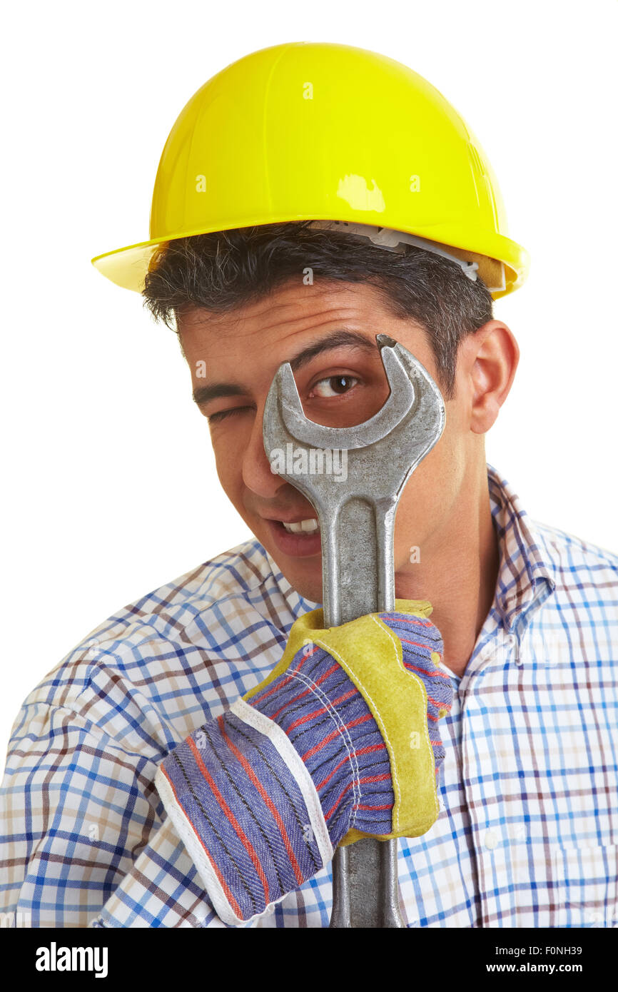 Construction worker looking through a big jaw wrench Stock Photo - Alamy