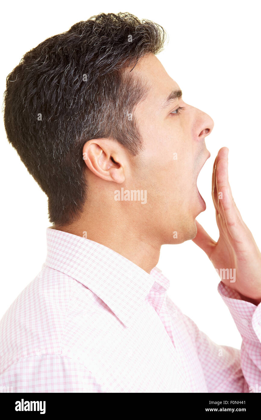 Man yawning and covering his mouth with his hand Stock Photo - Alamy