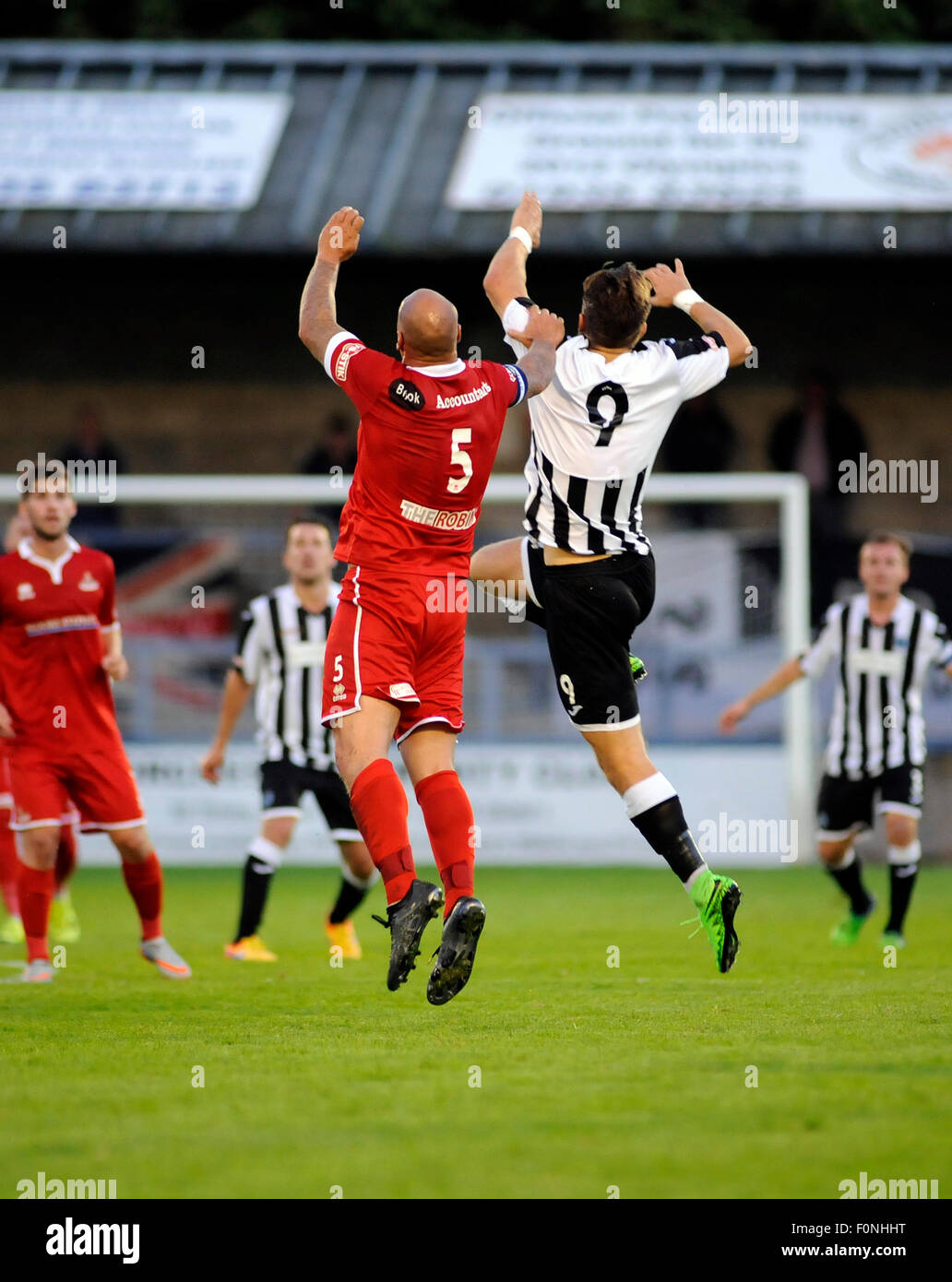 Football header jumping arms raised hi-res stock photography and images ...