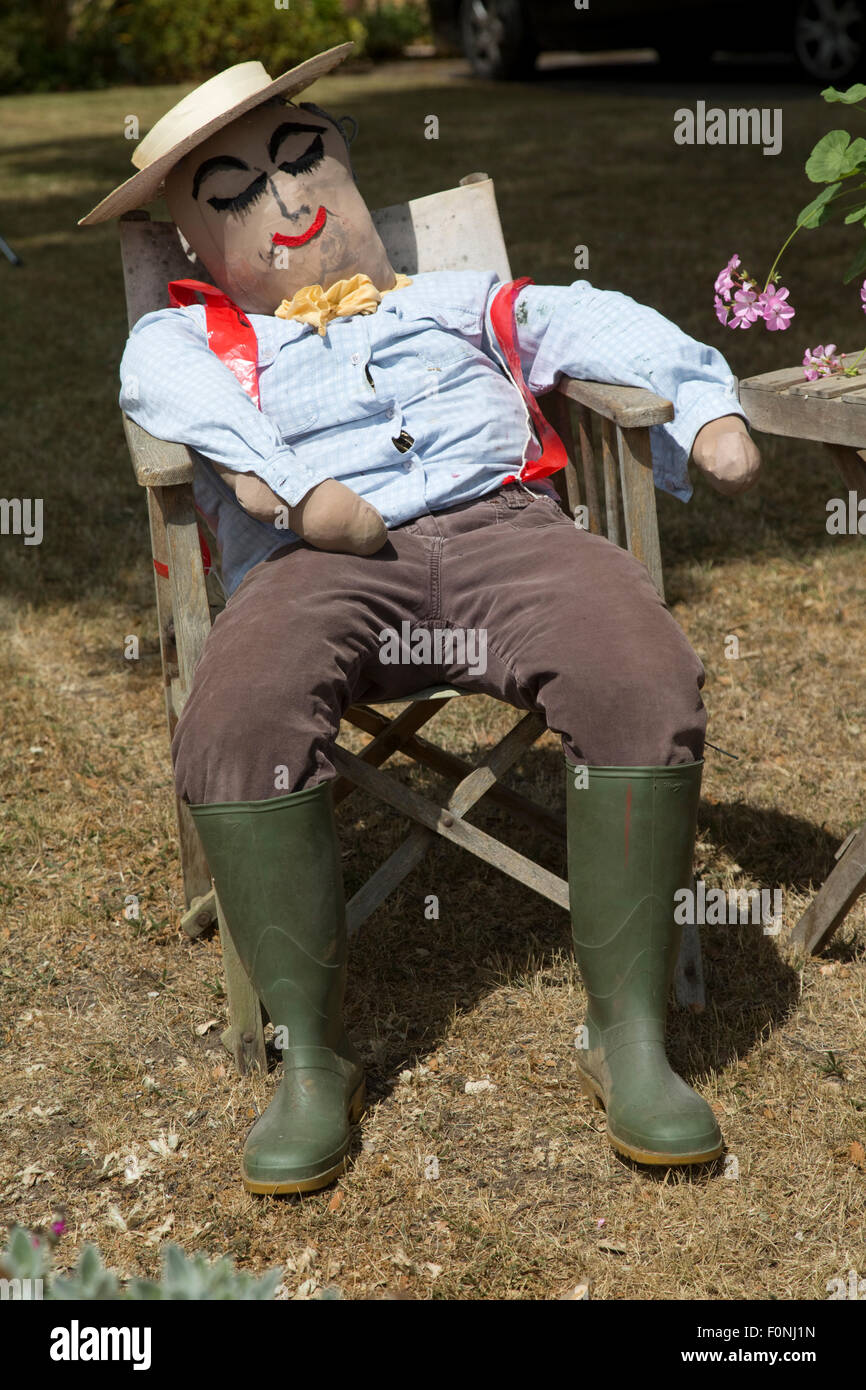 Sleeping scarecrow slumped in chair Fladbury UK Stock Photo - Alamy