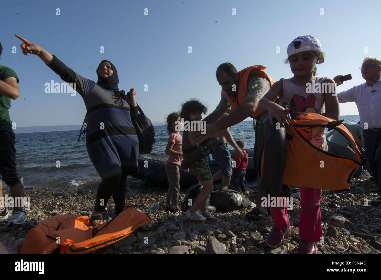 Lesbos, Greece. 19th Aug, 2015. Syrian refugees land on a beach on the ...