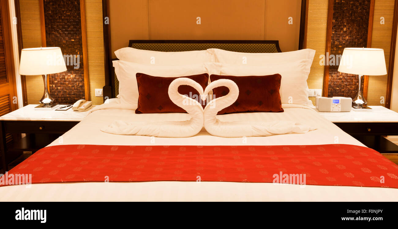 Hotel room with towel forming heart shape Stock Photo - Alamy
