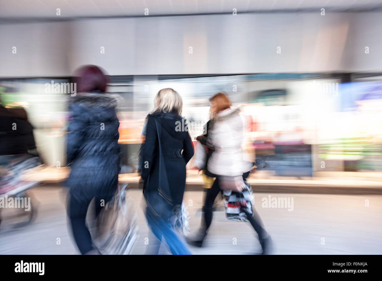Shopper walking against shop window Stock Photo - Alamy