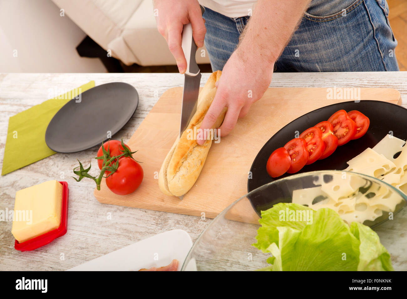 A young man preparing a sandwich in the kitchen Stock Photo - Alamy