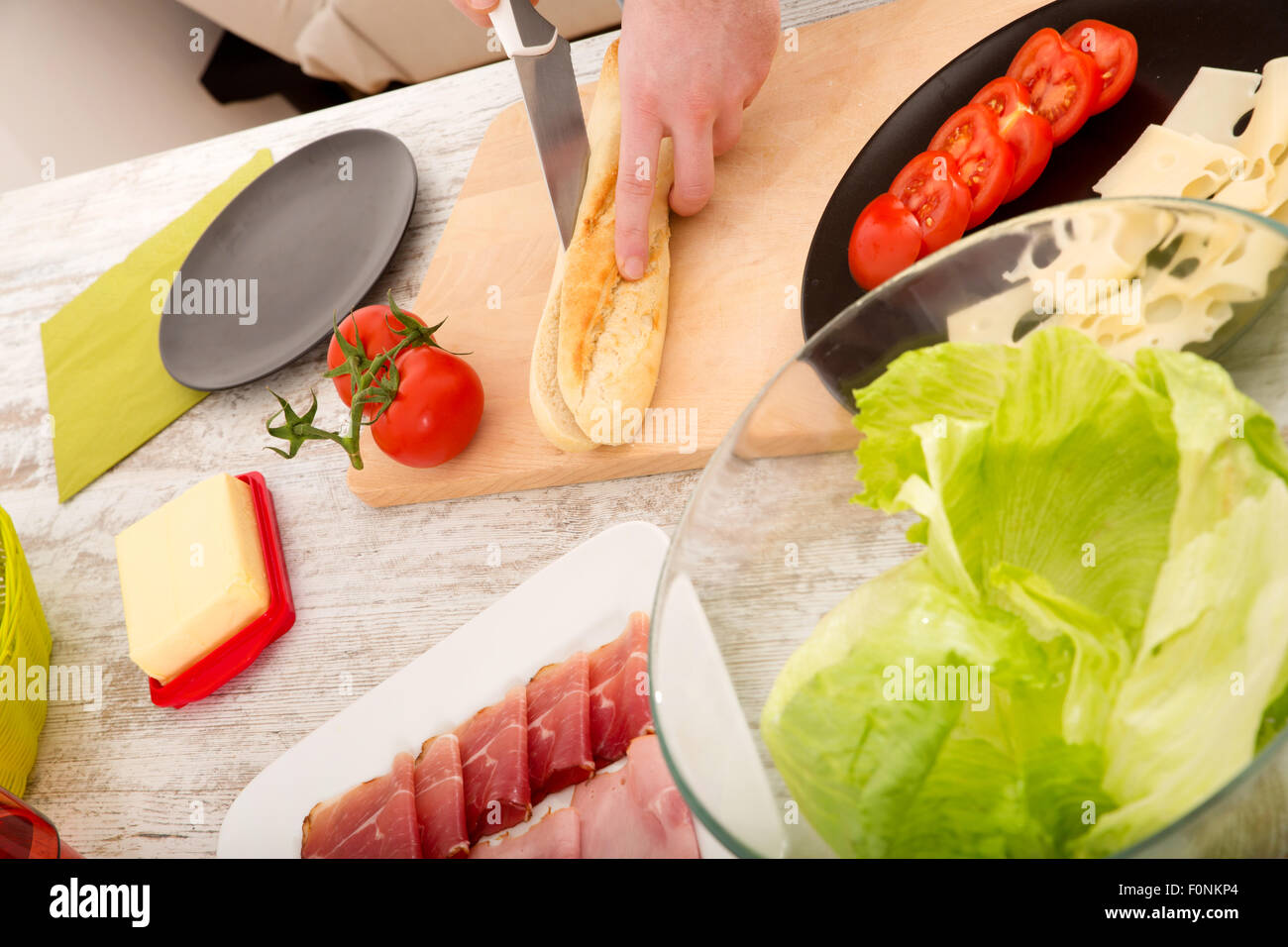 A young man preparing a sandwich in the kitchen Stock Photo - Alamy