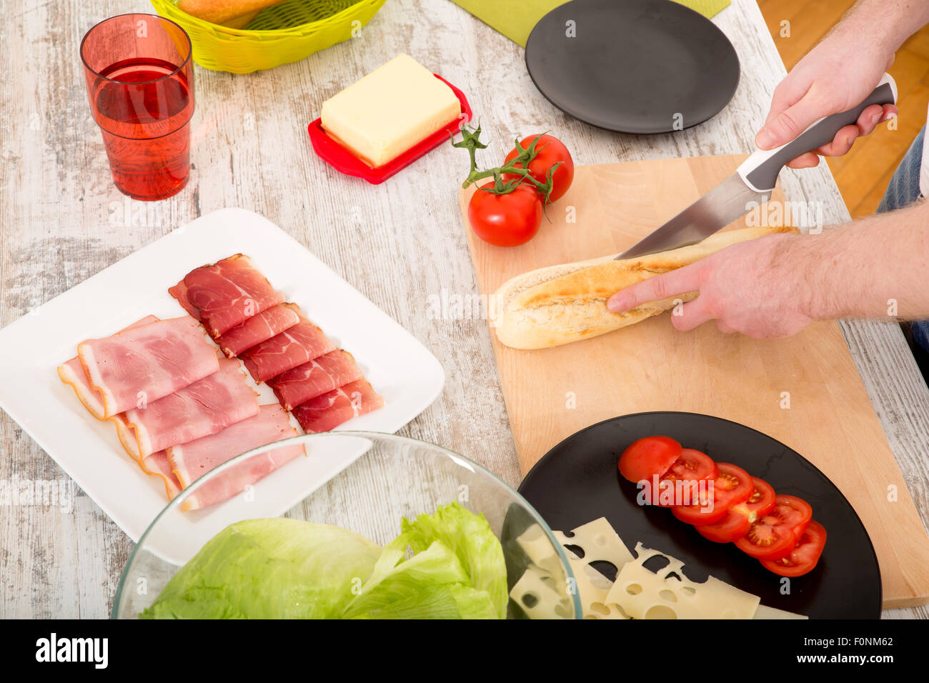 A young man preparing a sandwich in the kitchen Stock Photo - Alamy