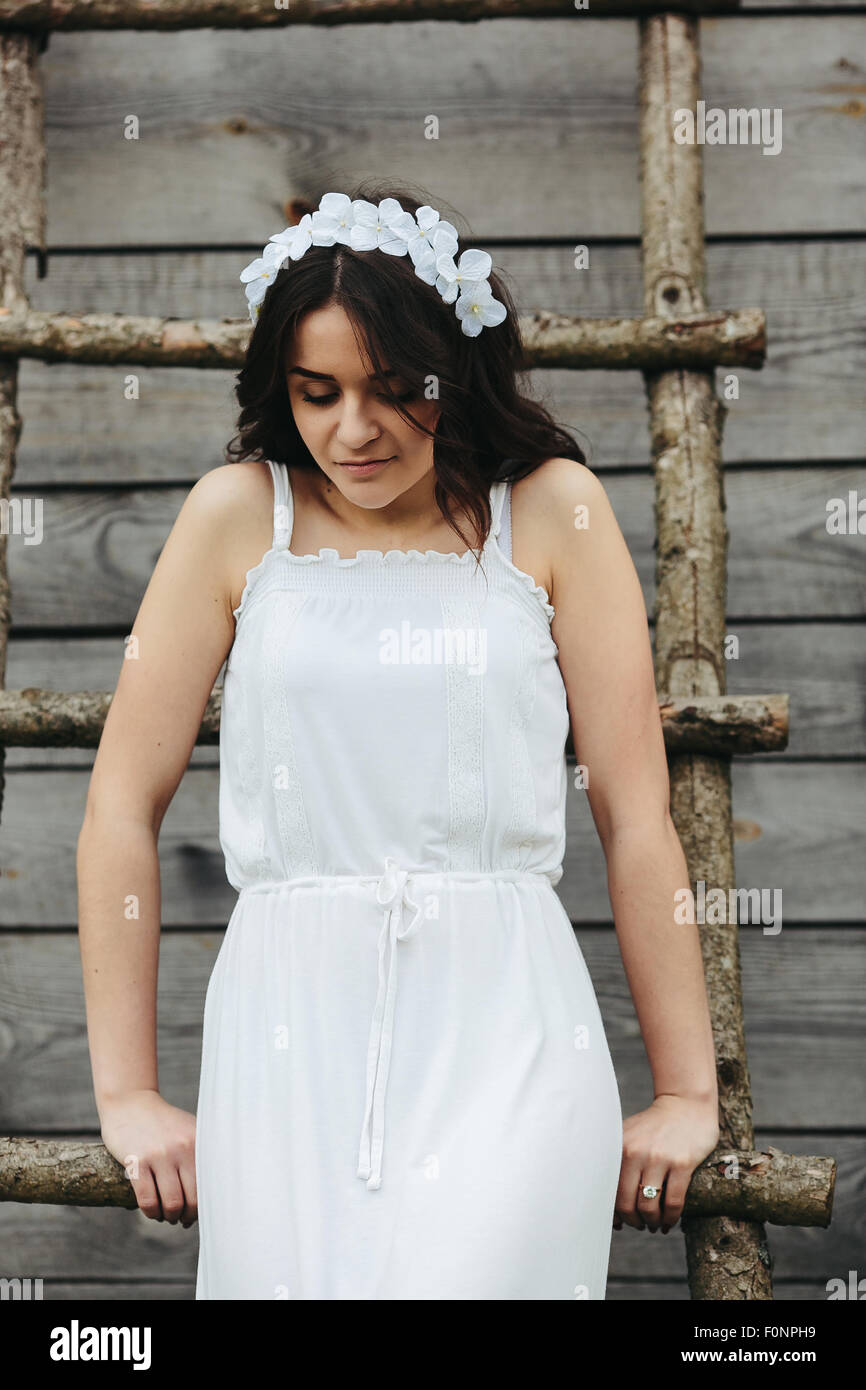 Girl climbing ladder into tree house Stock Photo - Alamy