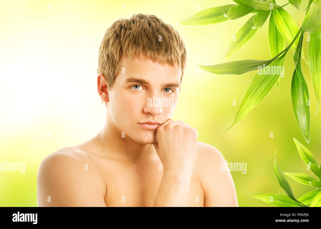 Handsome man over green abstract background Stock Photo - Alamy