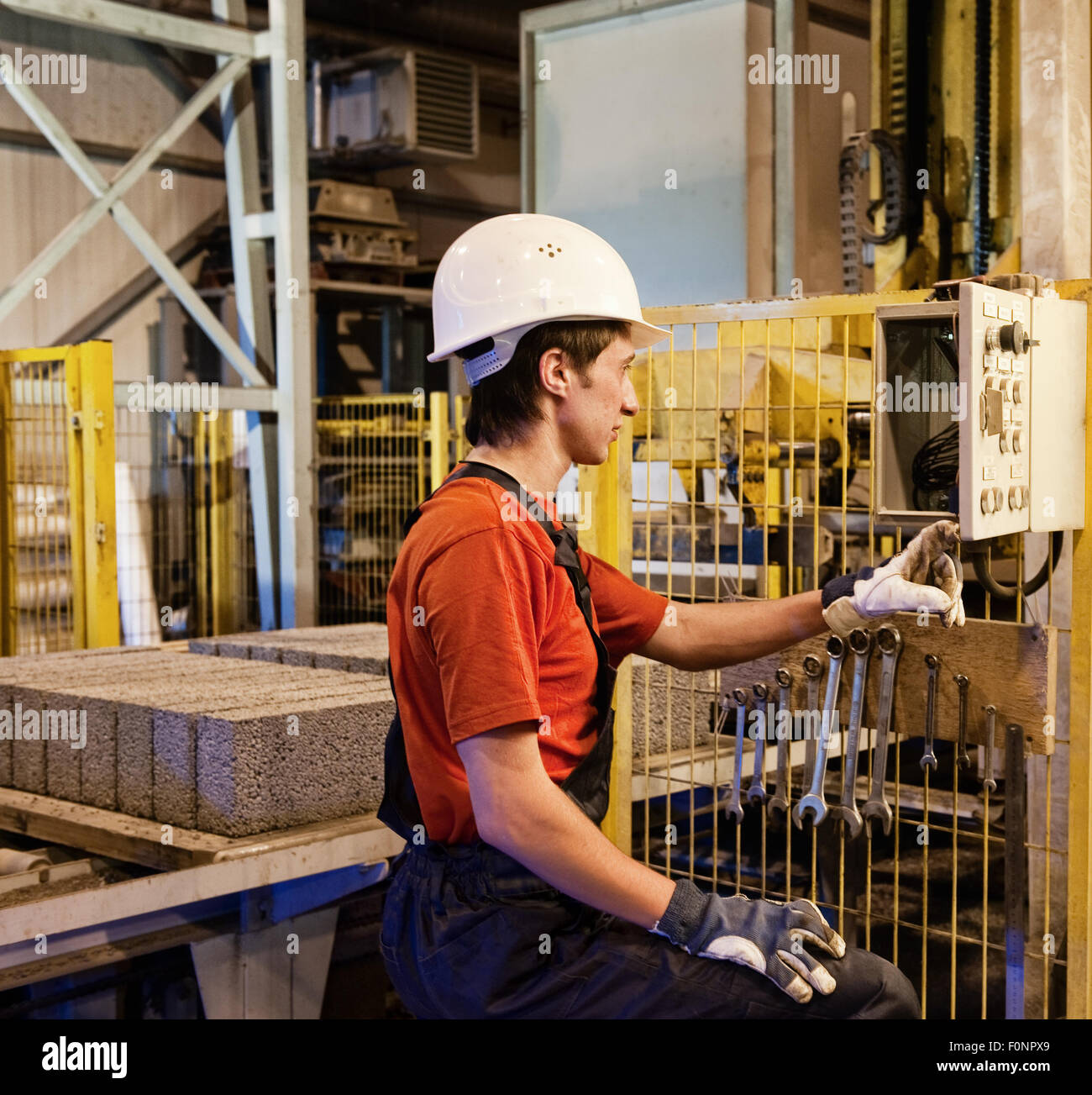 Factory worker fixing broken device Stock Photo - Alamy
